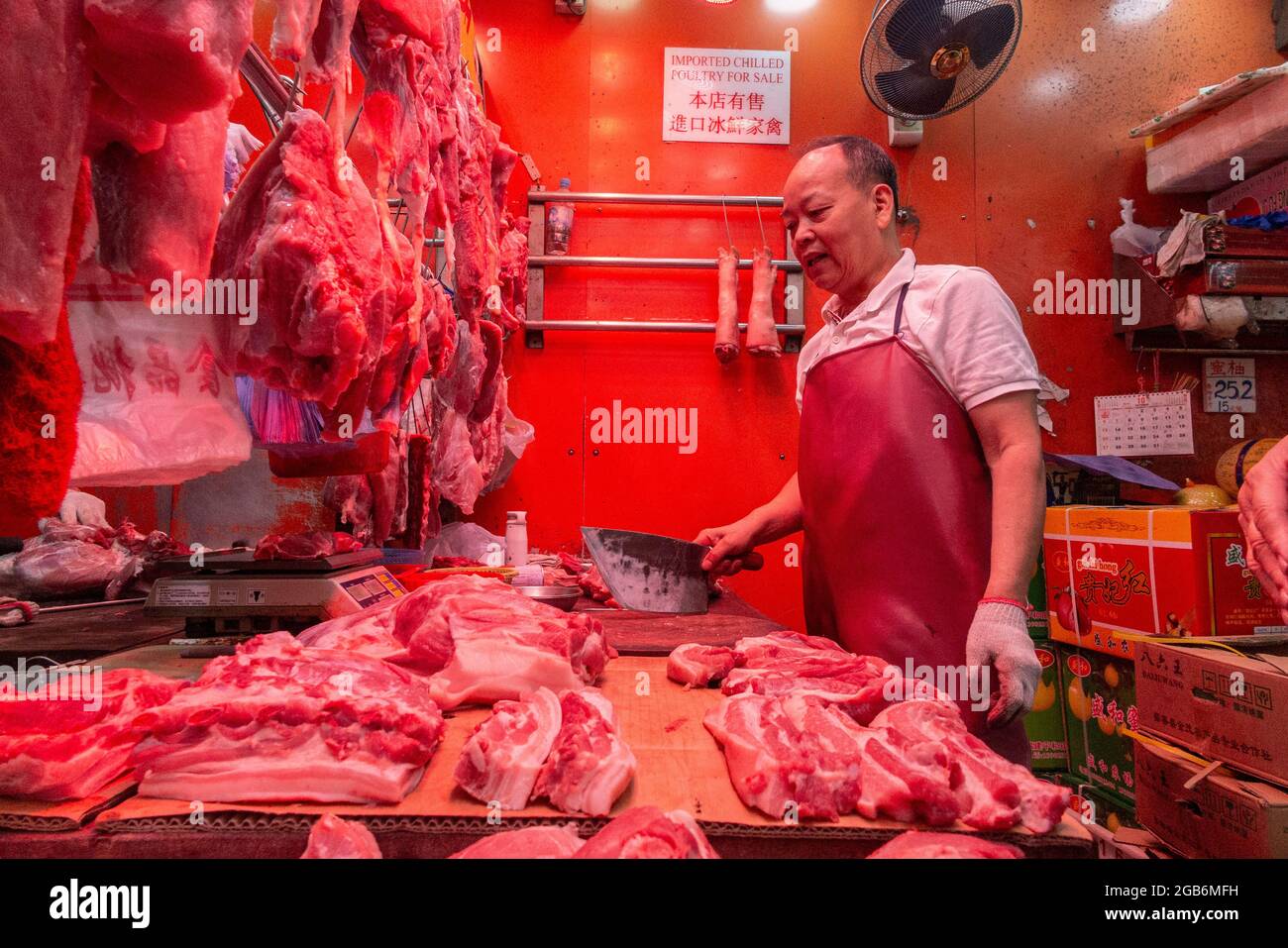 A Chinese butcher prepares meat in his shop in a village in China Stock ...
