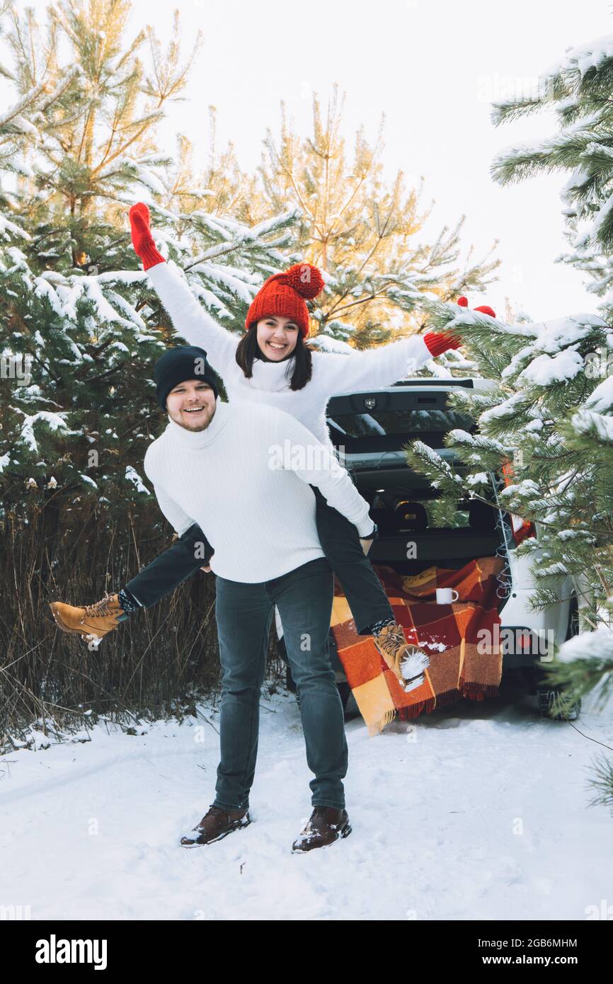 lovely couple at winter forest car on background piggyback Stock Photo ...