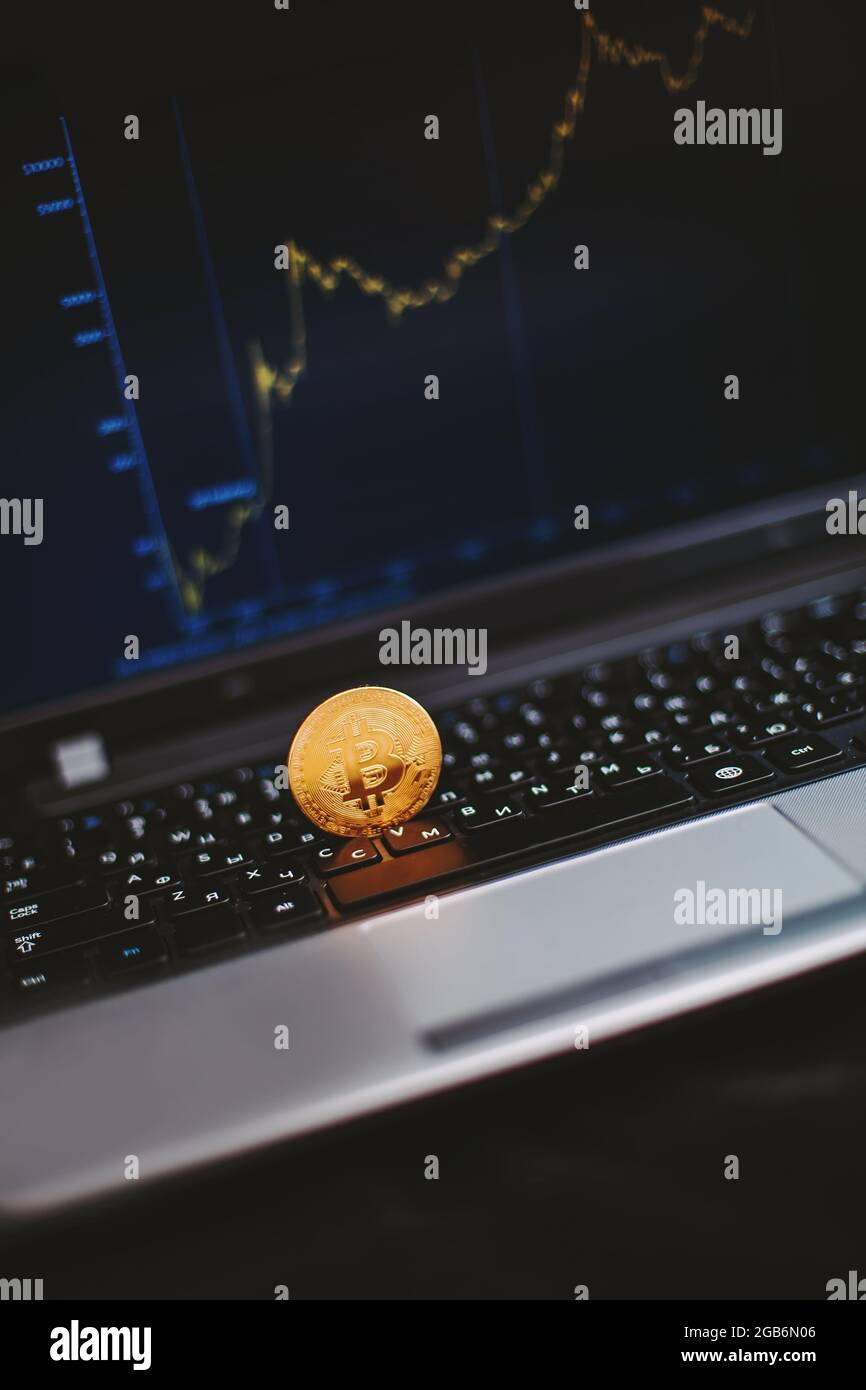 bitcoin on computer keyboard and growth chart Stock Photo - Alamy