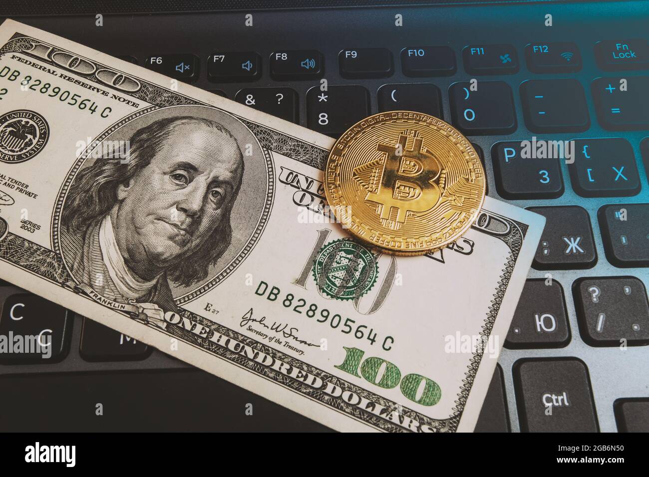 bitcoin on a computer keyboard and $ 100 Stock Photo - Alamy