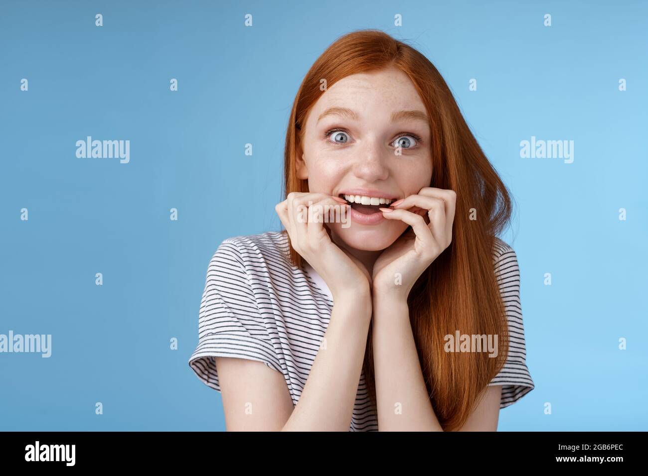 Excited amazed attractive redhead girl blue eyes look fascinated ...