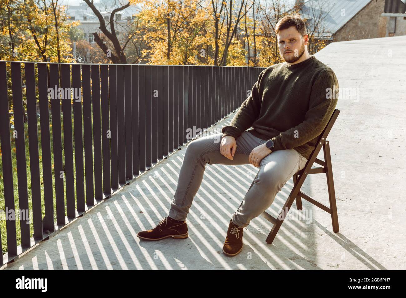 man with brutal face sitting on chair outdoors autumn sunny day copy ...