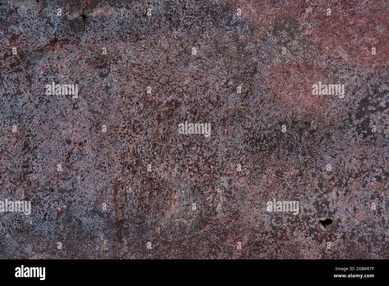 Rusty iron sheet with two little holes Stock Photo - Alamy