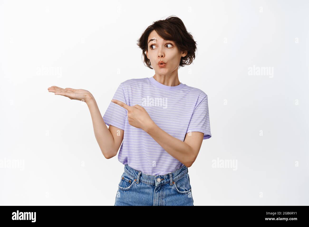 Surprised girl pointing on face hi-res stock photography and images - Alamy
