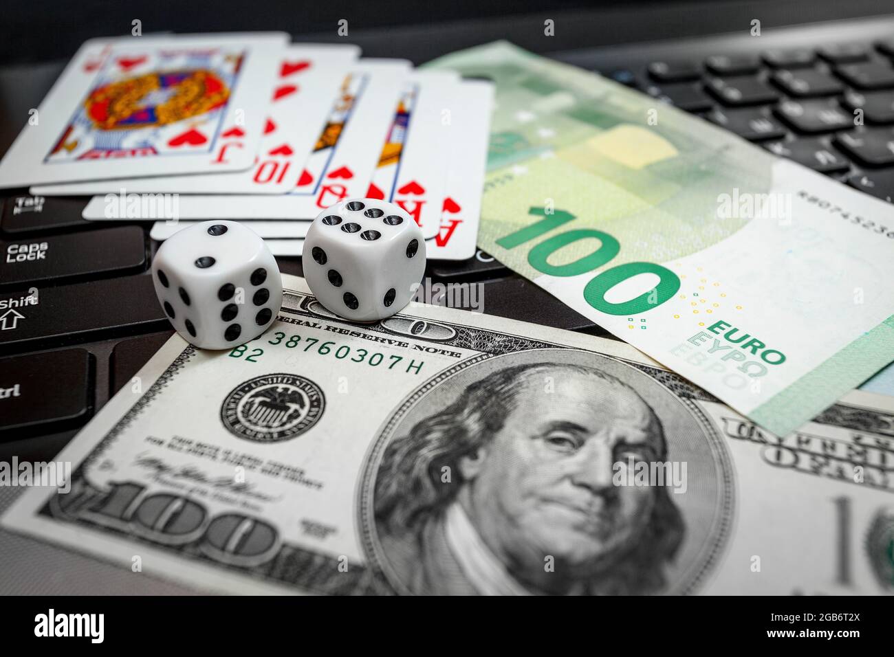 Dice, playing cards, dollars on a computer background Stock Photo - Alamy