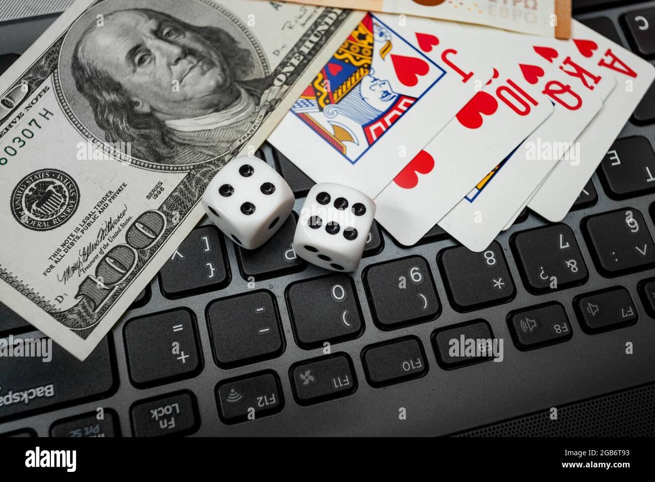 Dice, playing cards, dollars on a computer background Stock Photo - Alamy