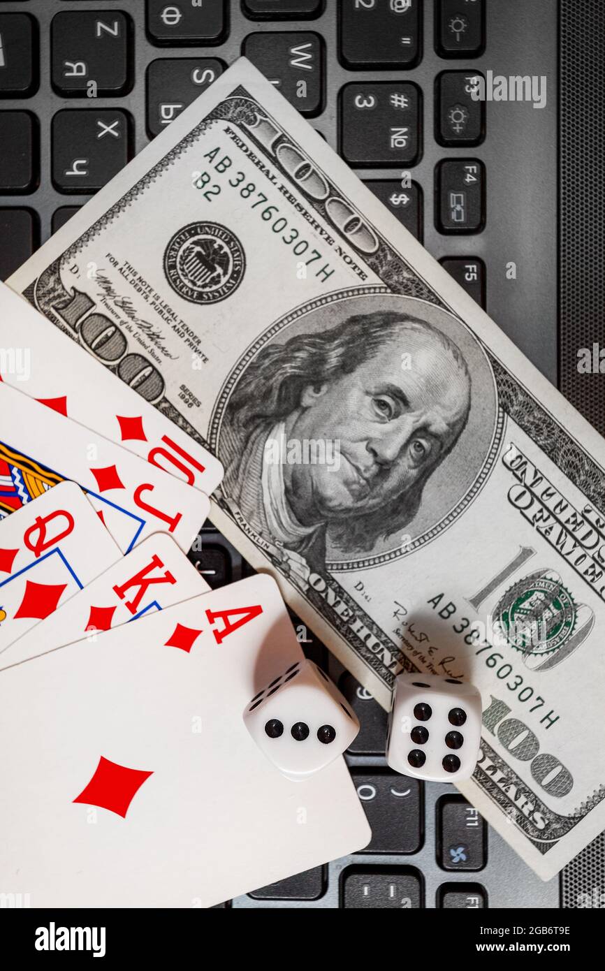 Chisinau, Moldova - 20. 12. 2020 dice, playing cards on laptop keyboard ...