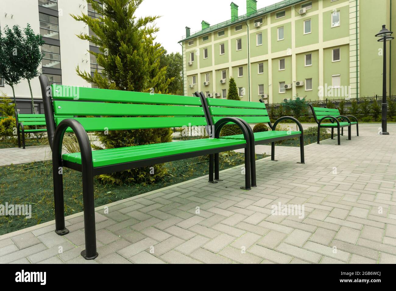 beautiful green wooden bench in the courtyard of a new residential ...