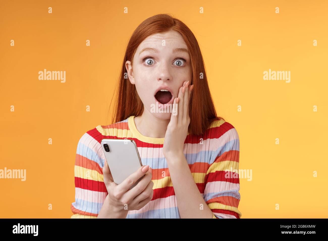 Concerned shocked emotive redhead girl find out stunning news look ...