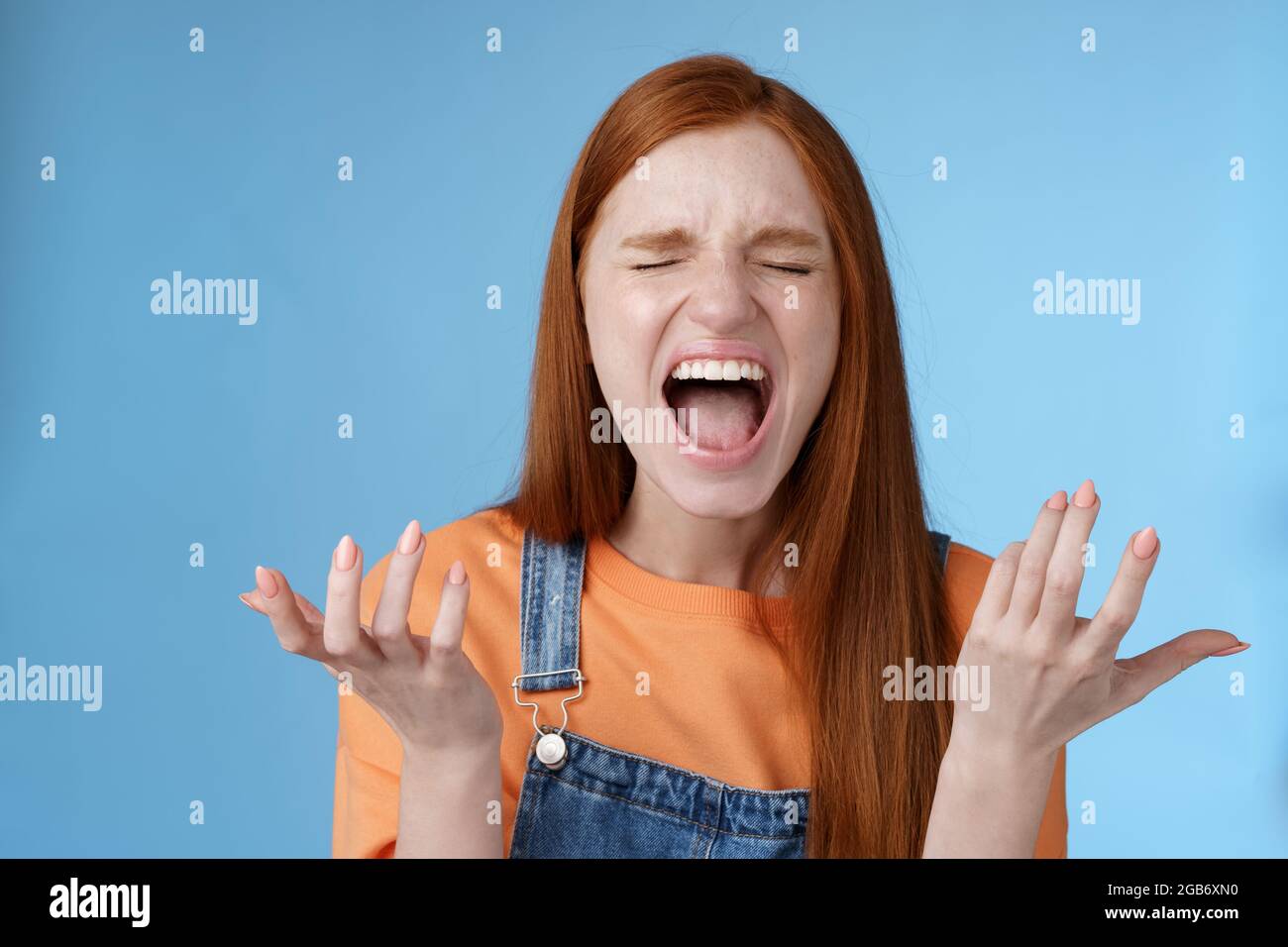 Pissed outraged moody redhead girl shouting complaining angry standing ...