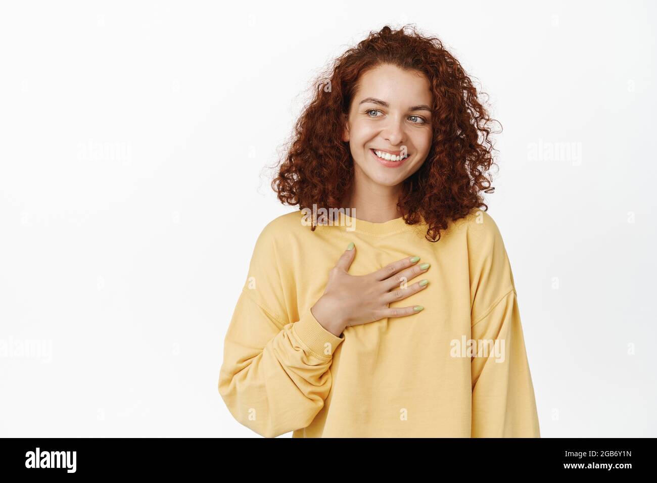 Young modern woman with curly hair, smiling and laughing, looking ...