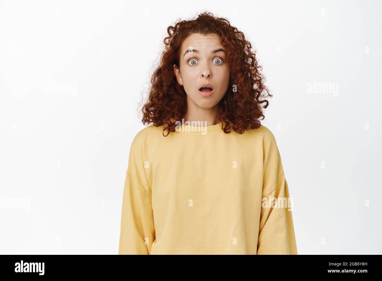 Image of redhead girl drop jaw, look in awe surprised at camera ...