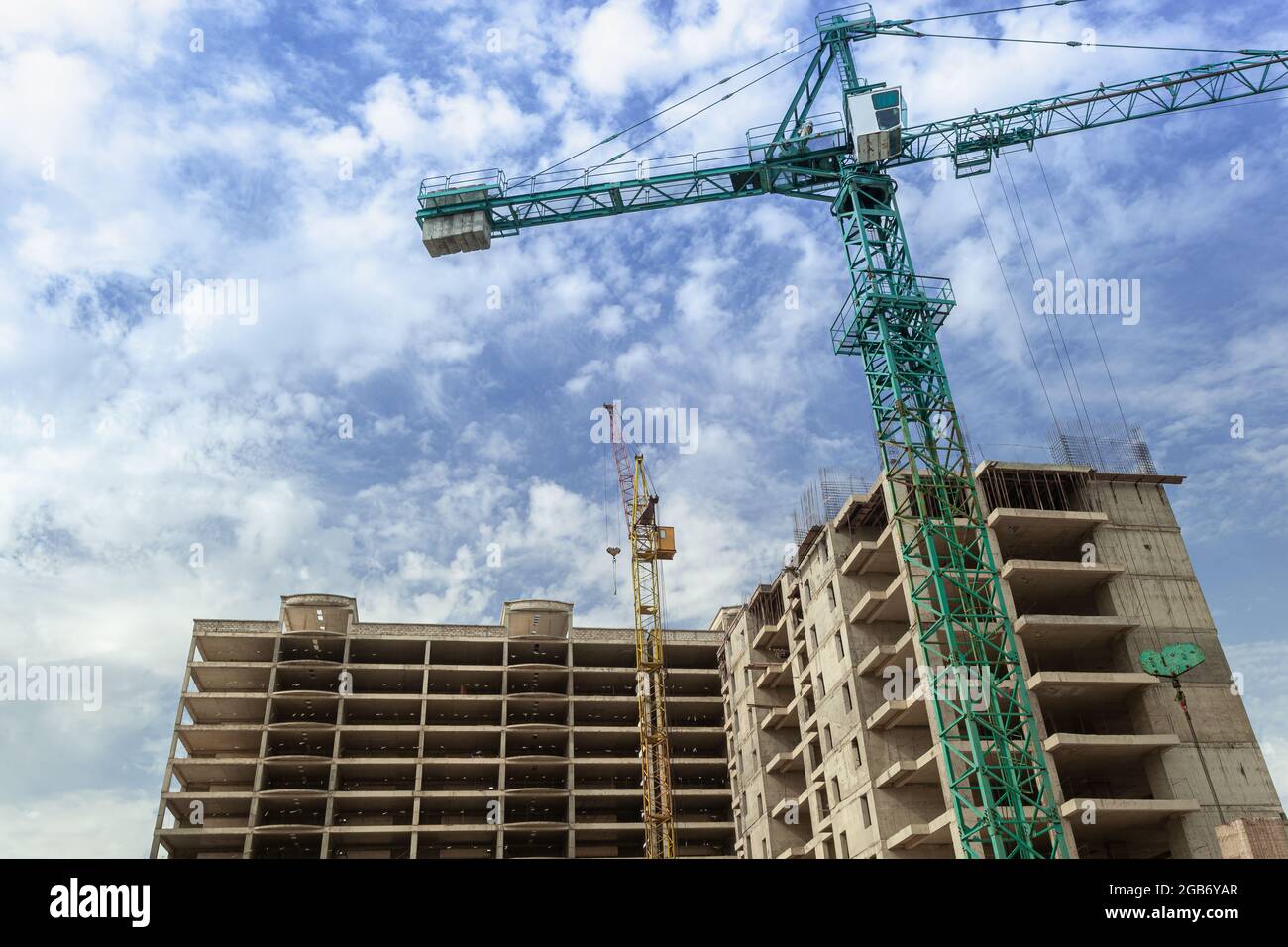 Multi-storey residential building under construction and crane on a ...