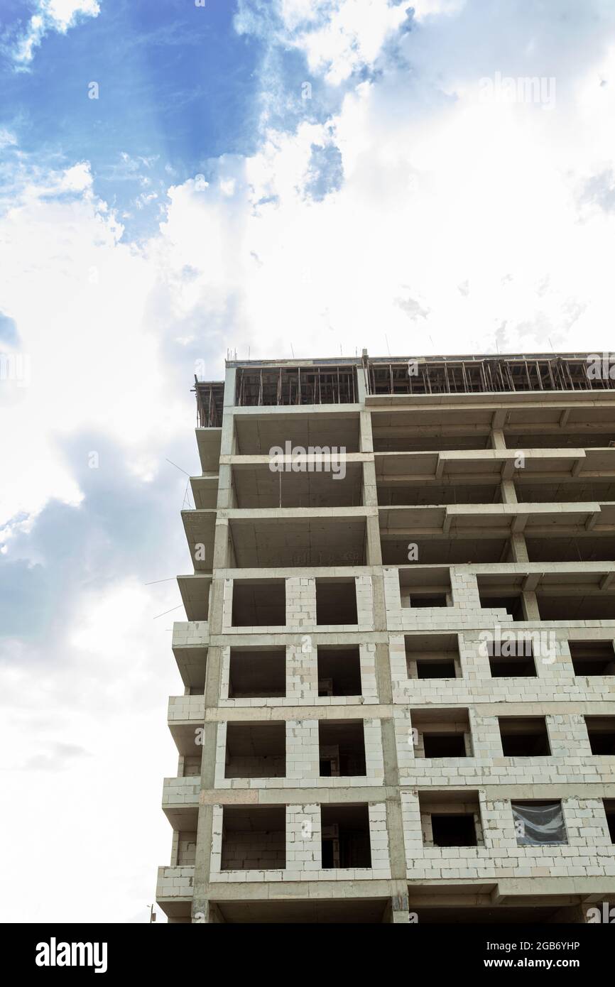 Multi-storey residential building under construction and crane on a ...