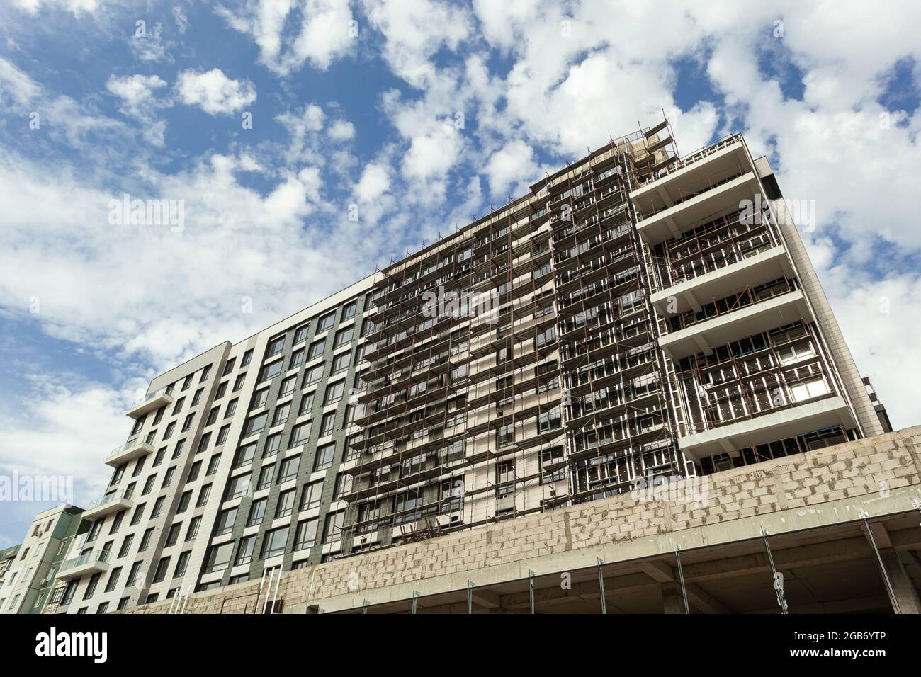 Multi-storey residential building under construction and crane on a ...