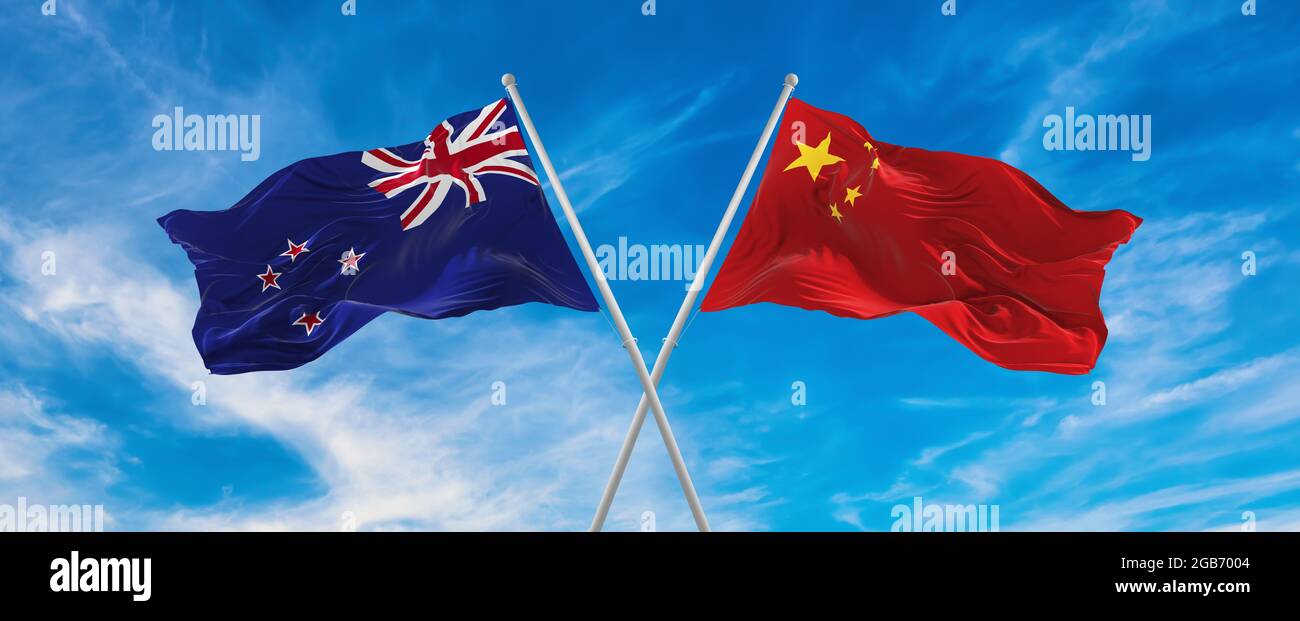 flags of China and New Zealand waving in the wind on flagpoles against ...