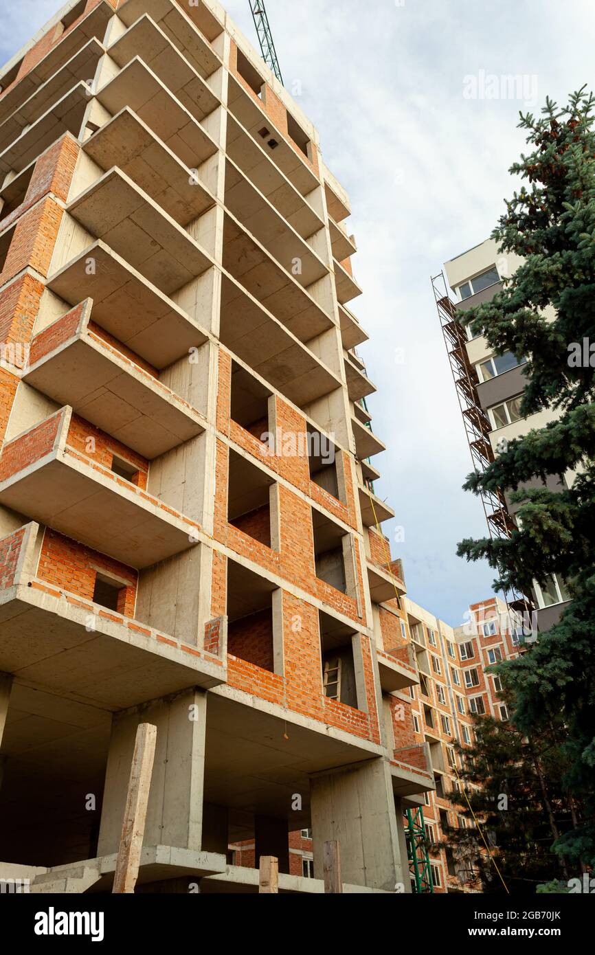 Multi-storey residential building under construction and crane on a ...