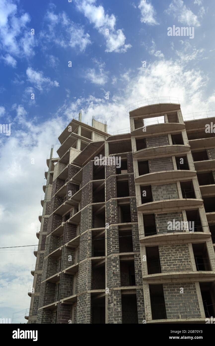 Multi-storey residential building under construction and crane on a ...