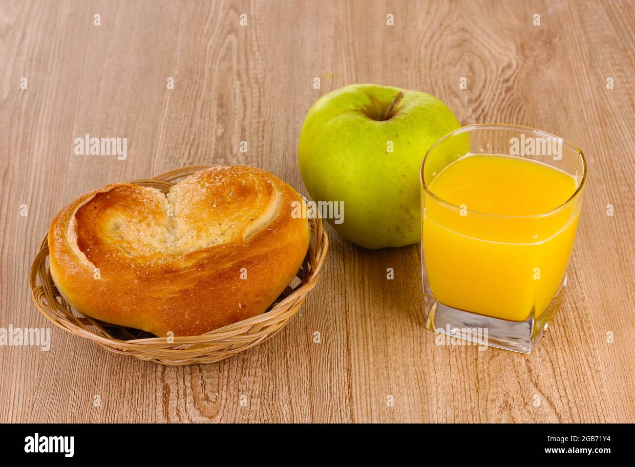 Classical breakfast. Orange juice and bun Stock Photo - Alamy