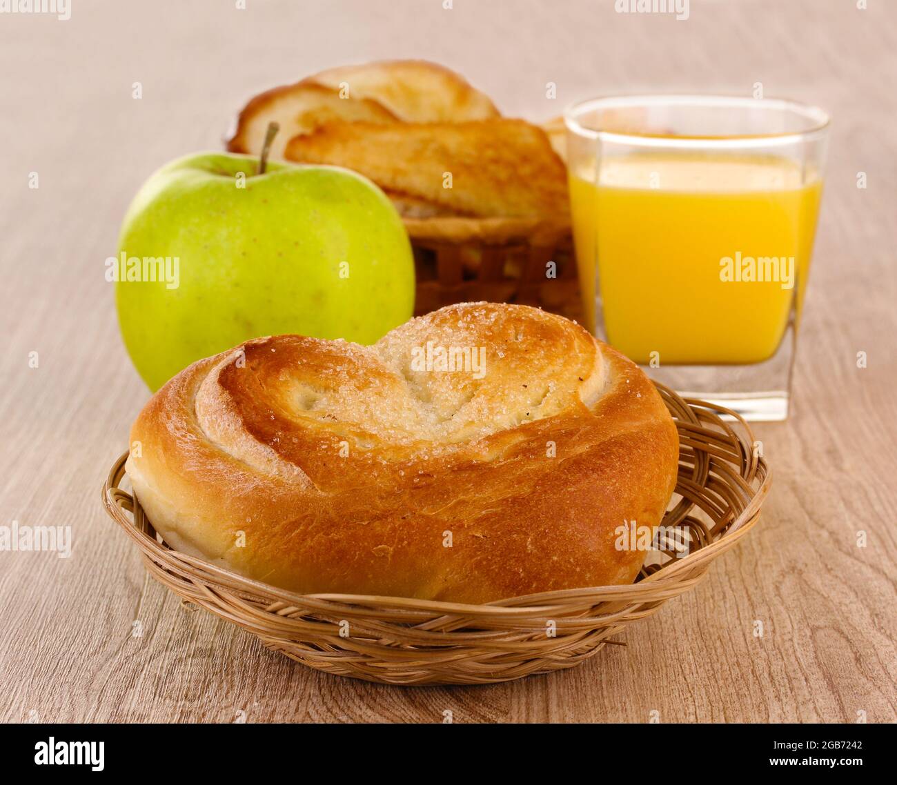 Classical breakfast. Orange juice and bun Stock Photo - Alamy
