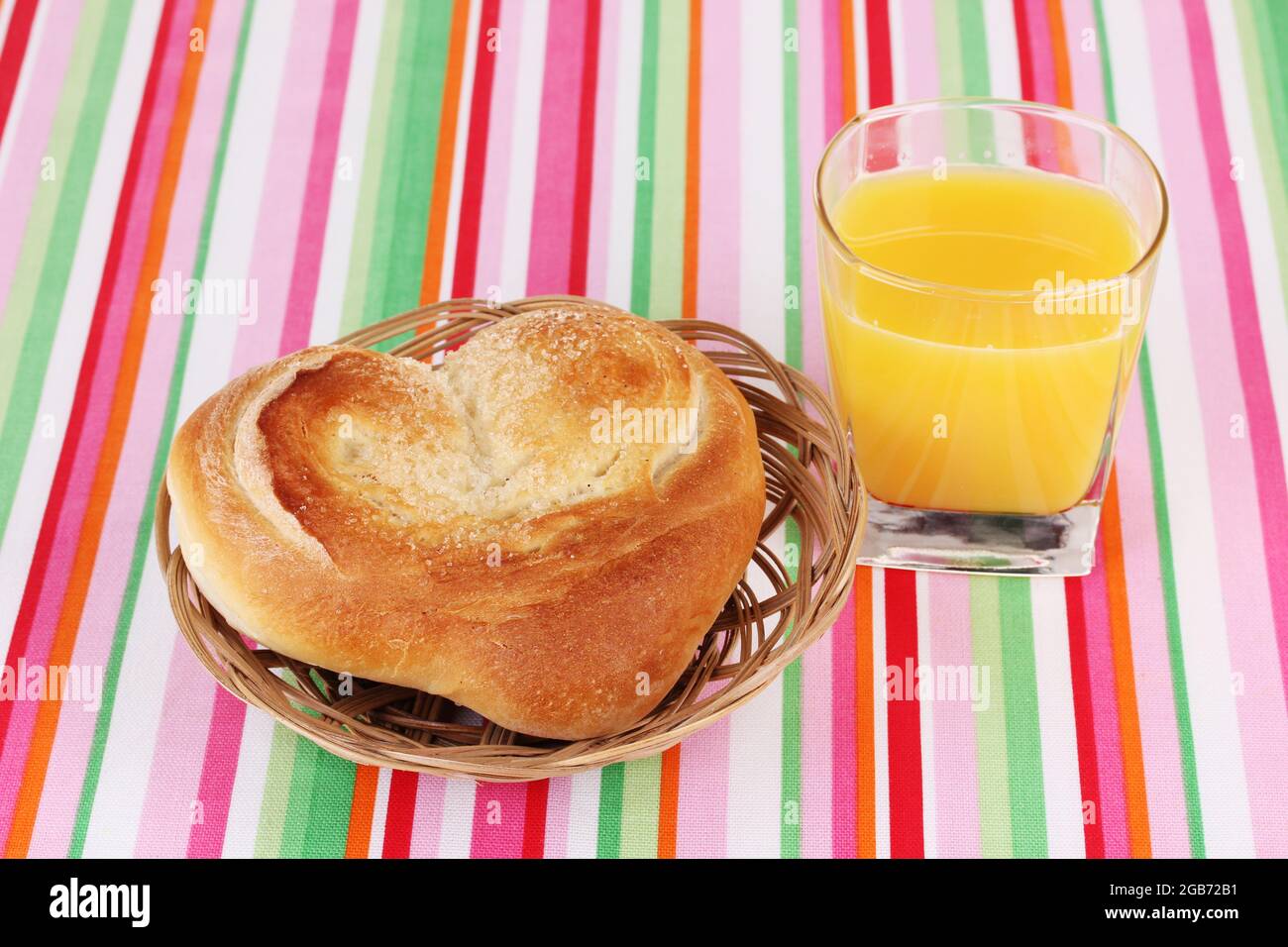 Classical breakfast. Orange juice and bun Stock Photo - Alamy