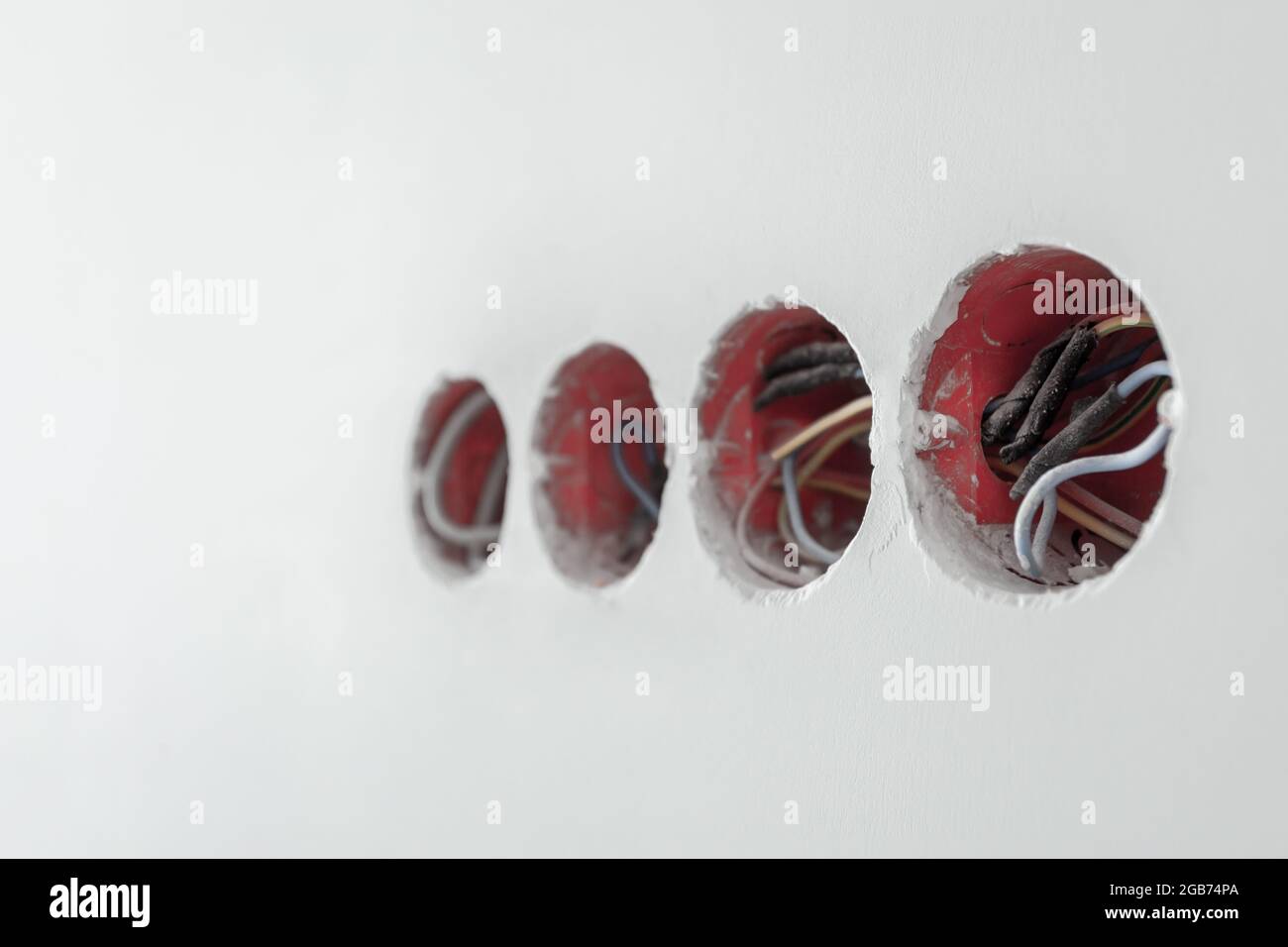 sockets with wires on a putty wall Stock Photo - Alamy