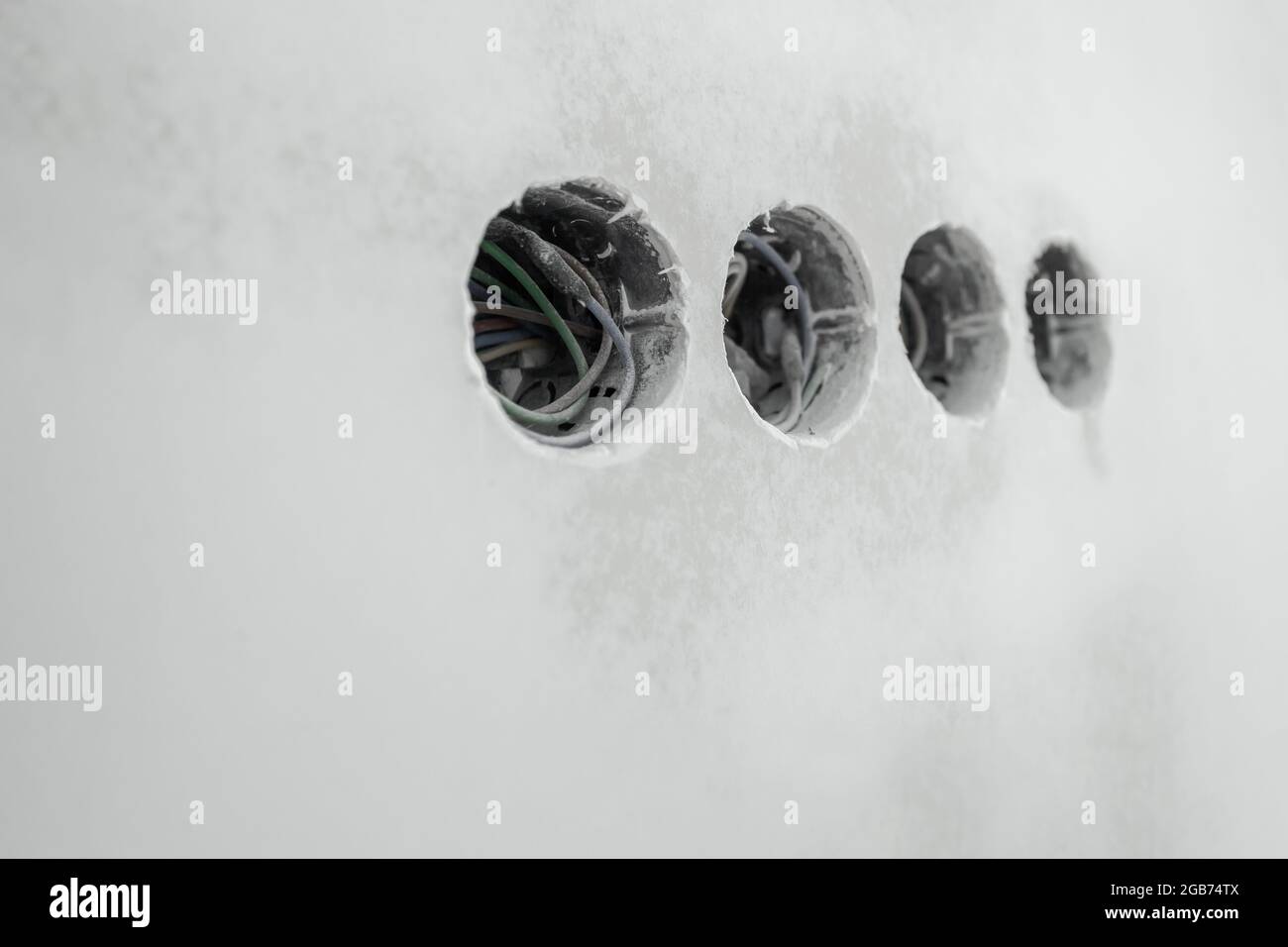 sockets with wires on a putty wall Stock Photo - Alamy