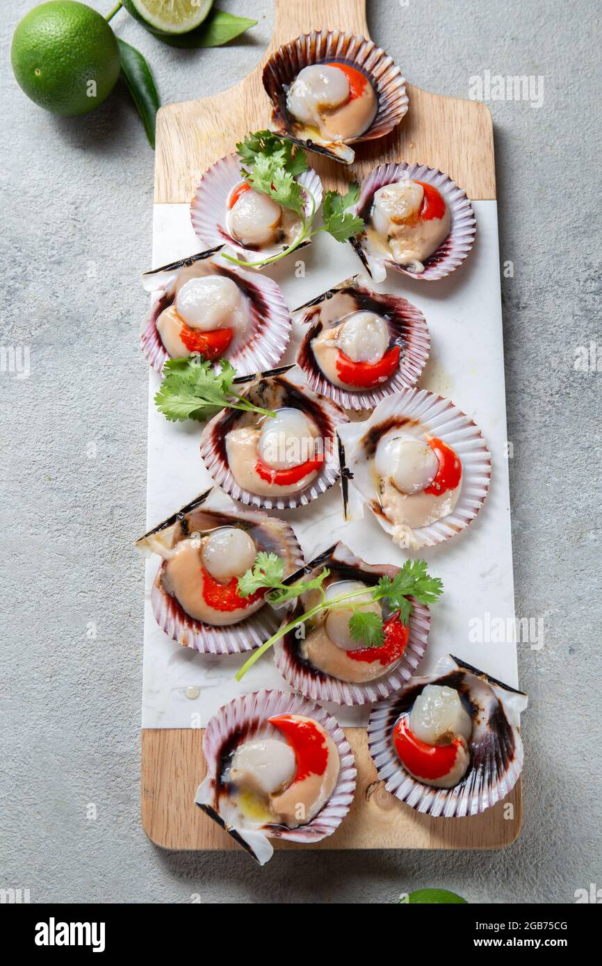 Raw Seafood shellfish scallops with lemon, cilantro and michelada beer ...