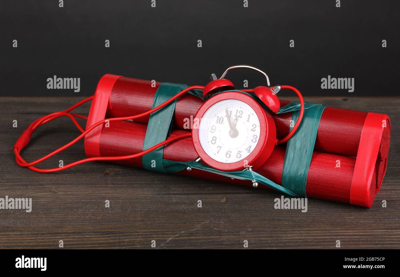 Timebomb made of dynamite on wooden table on grey background Stock ...