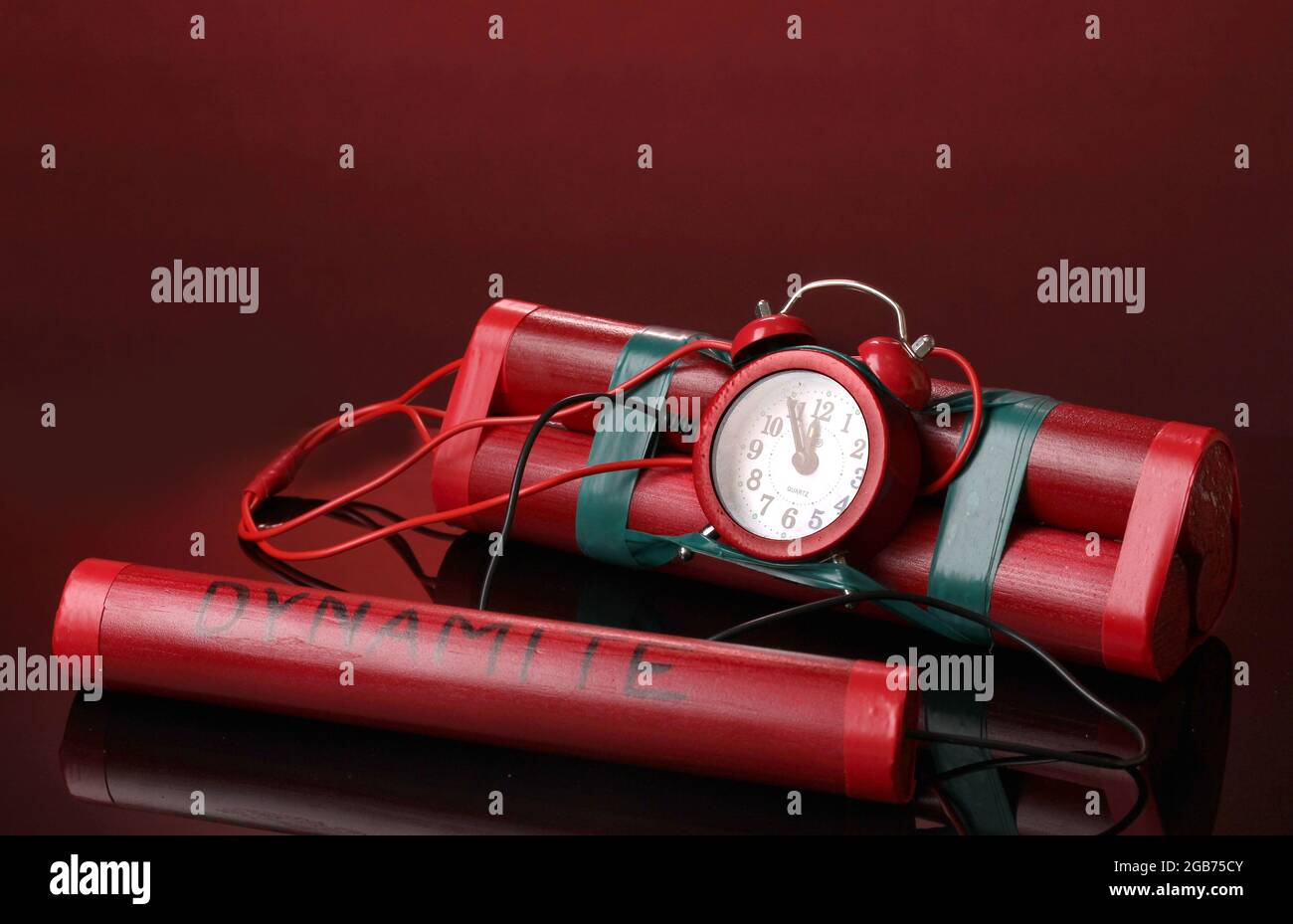 Timebomb made of dynamite on red background Stock Photo - Alamy
