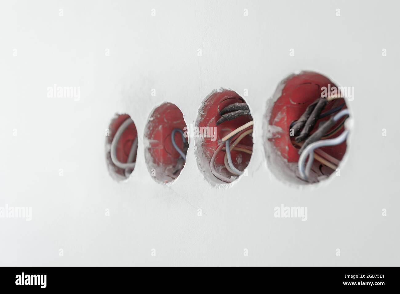 sockets with wires on a putty wall Stock Photo - Alamy