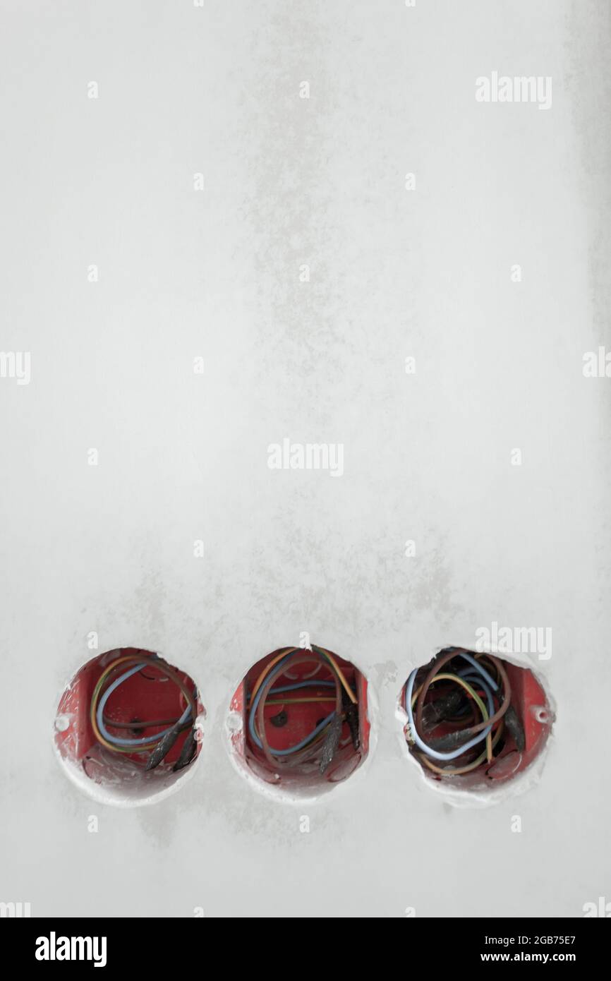 sockets with wires on a putty wall Stock Photo - Alamy