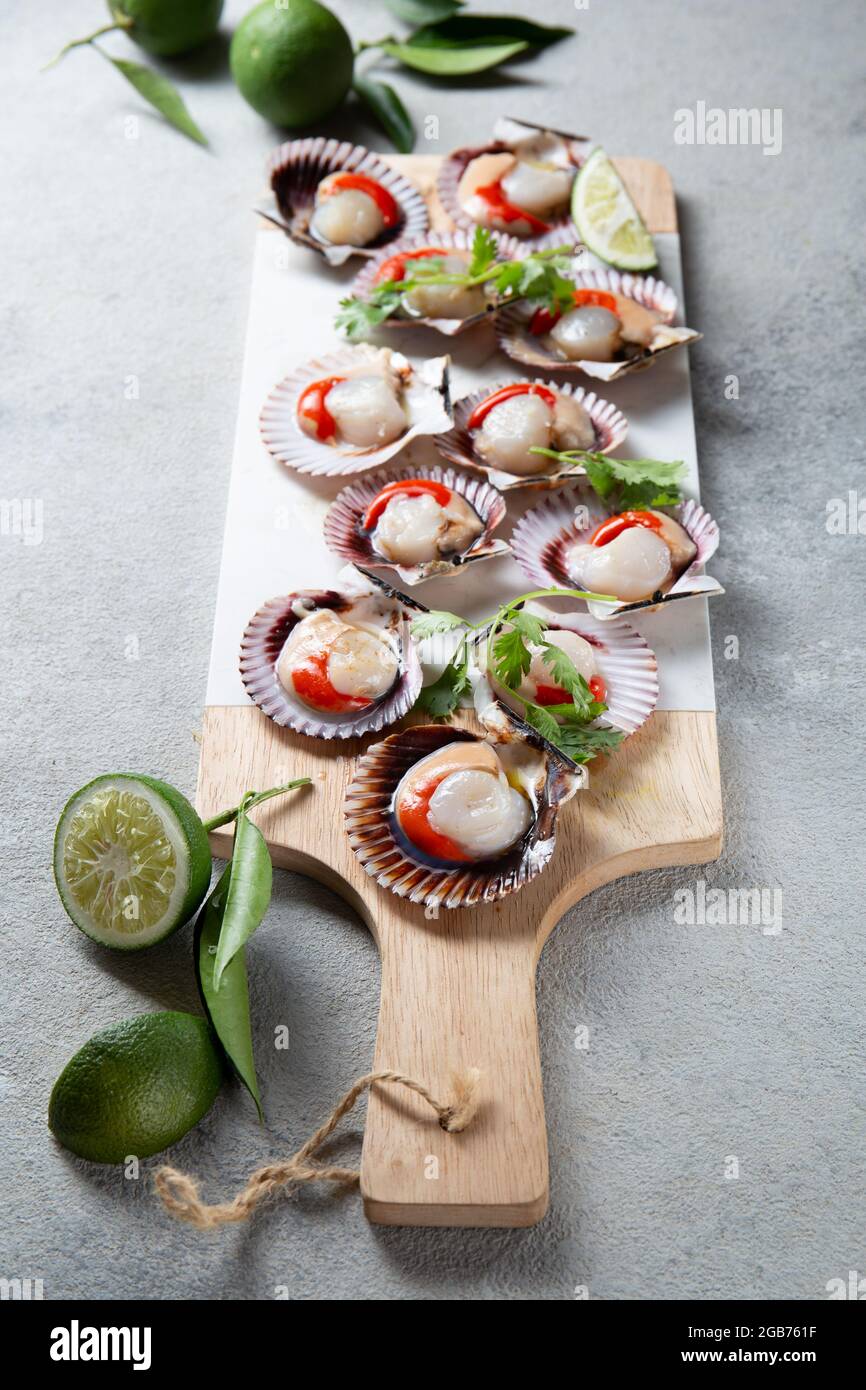 Raw Seafood shellfish scallops with lemon, cilantro and michelada beer ...