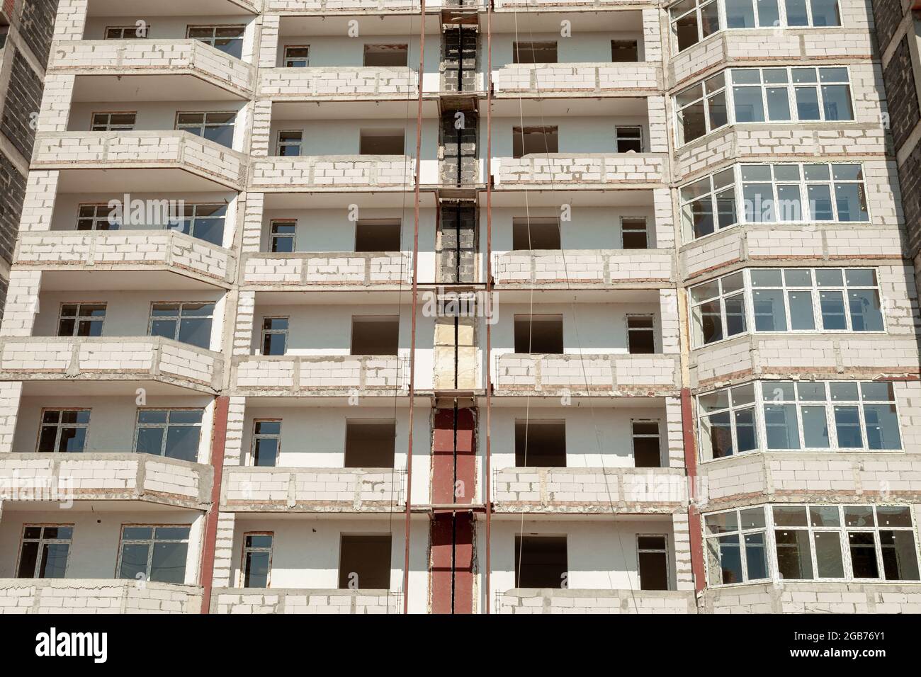 Multi-storey residential building under construction and crane on a ...
