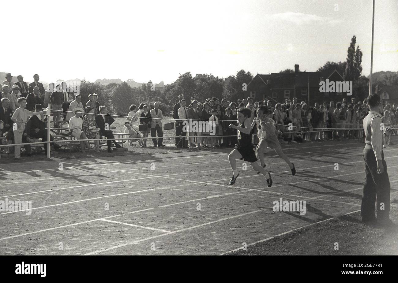 1964, historical, watched by spectators, two teenage boys competing in ...