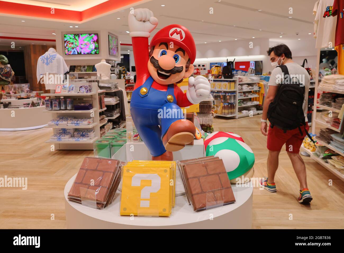 A visitor walks past a large sculpture of Mario seen displayed at ...