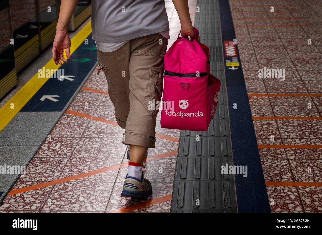 A delivery worker from a take out food delivery company Food Panda is ...