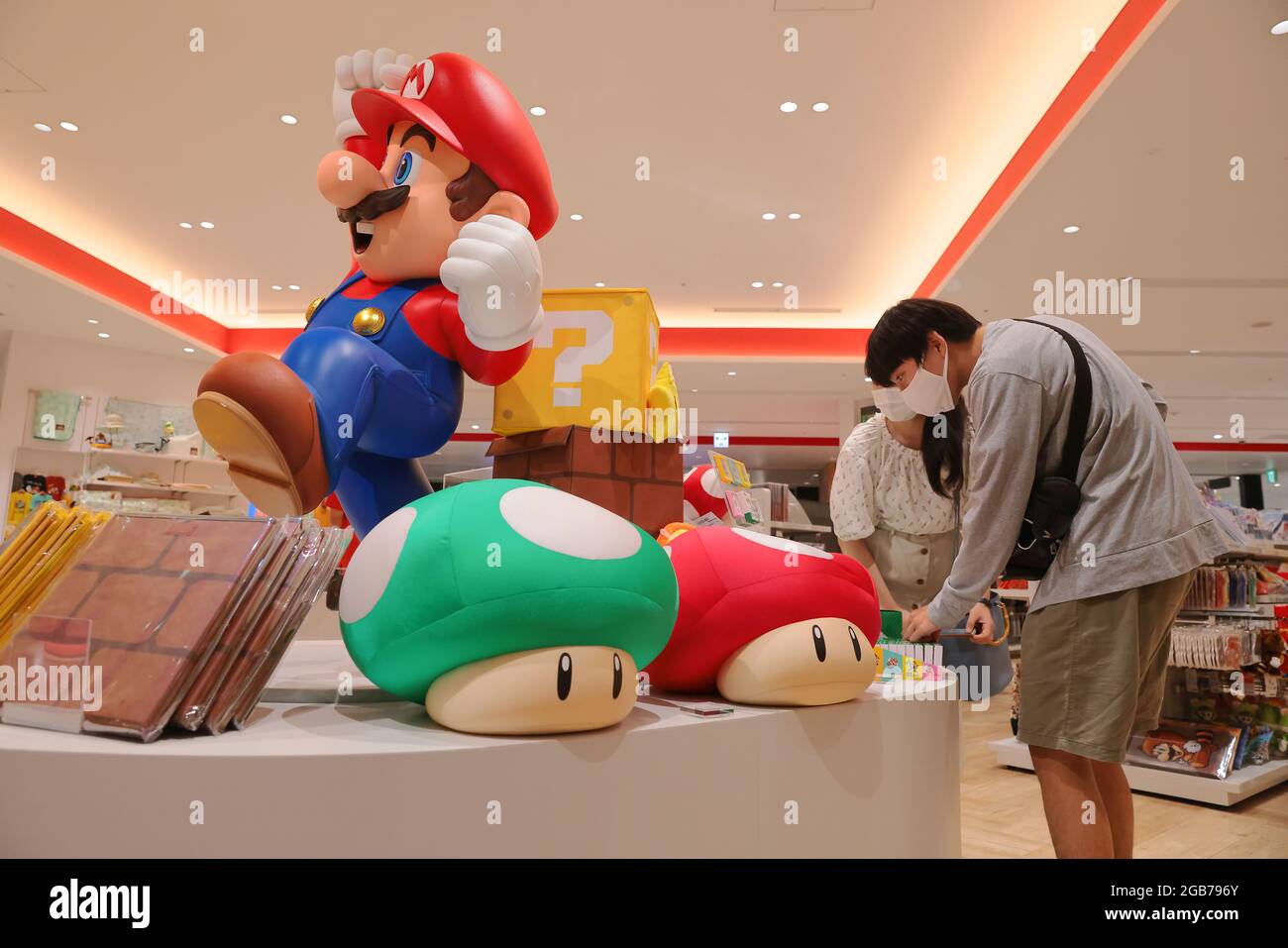 Tokyo, Japan. 02nd Aug, 2021. Visitors look at Super Mario themed ...