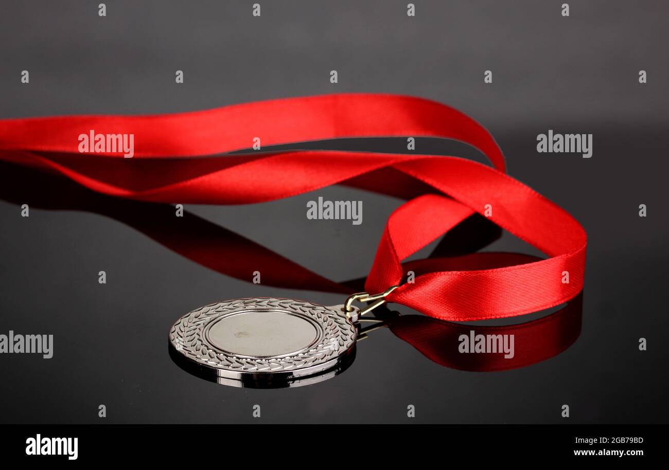 Silver medal on grey background Stock Photo - Alamy
