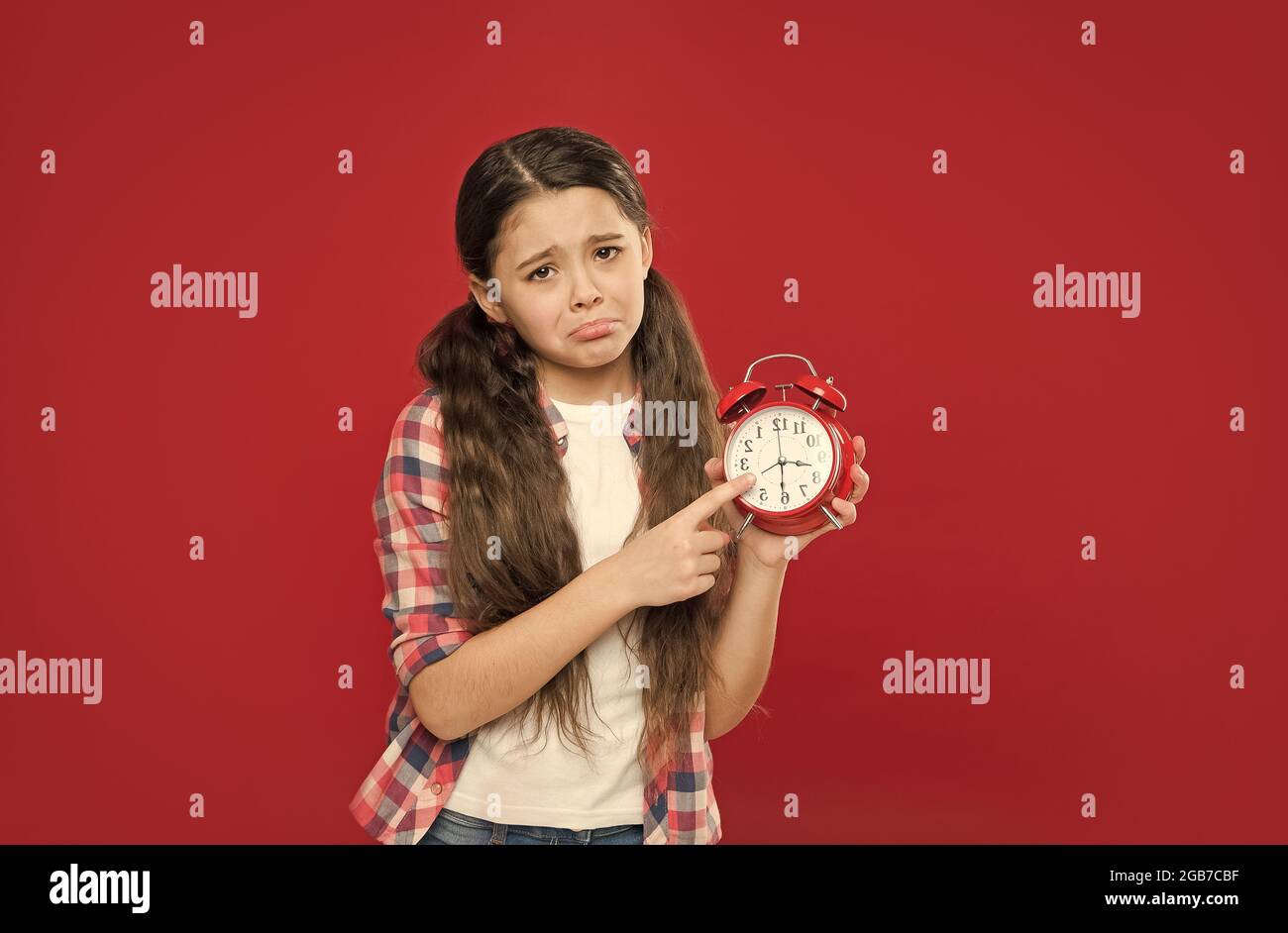 sad teen girl pointing finger on retro alarm clock, countdown Stock ...