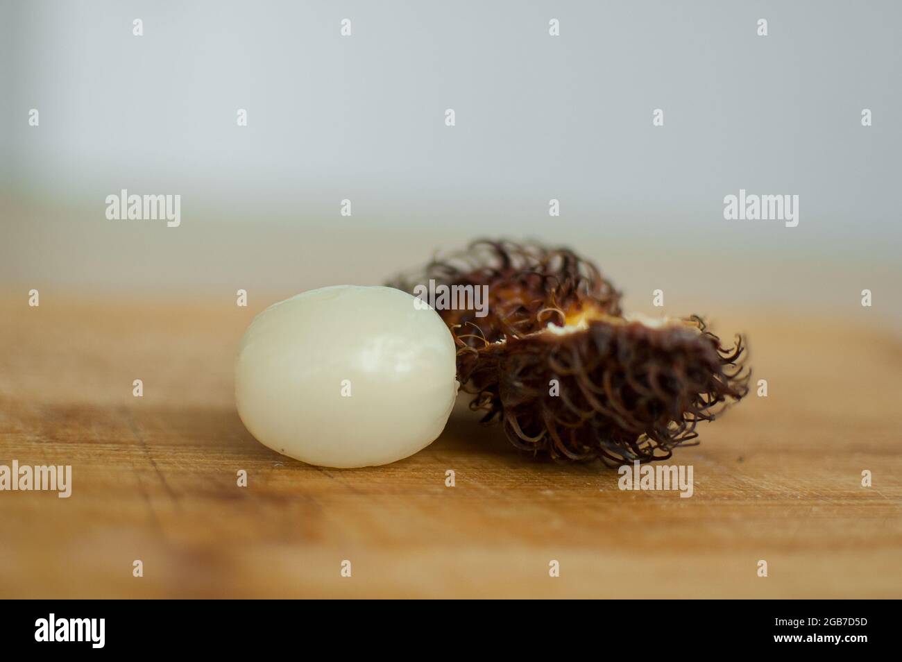 Ripe rambutan on wooden table. Healthy food, fresh organic fruit Stock ...