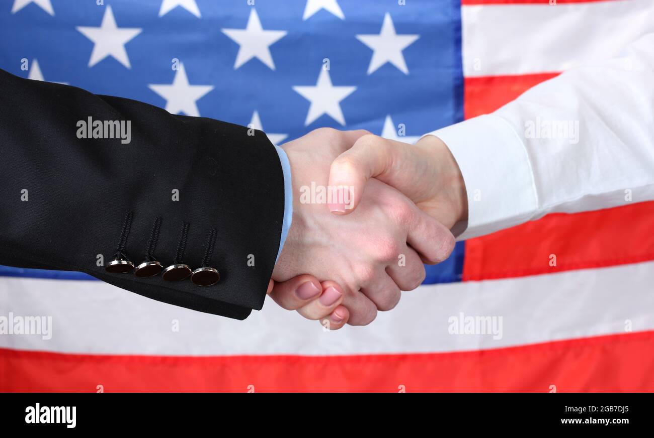 Business handshake on american flag background Stock Photo - Alamy