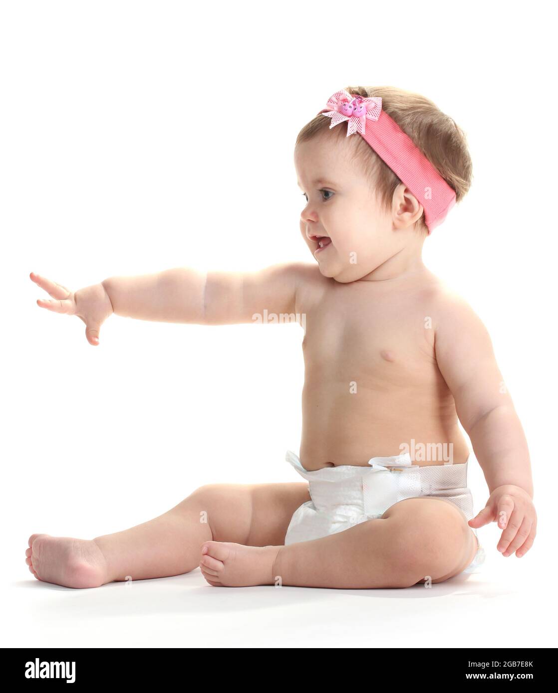 Cute baby girl sitting and pulling hand isolated on white Stock Photo ...