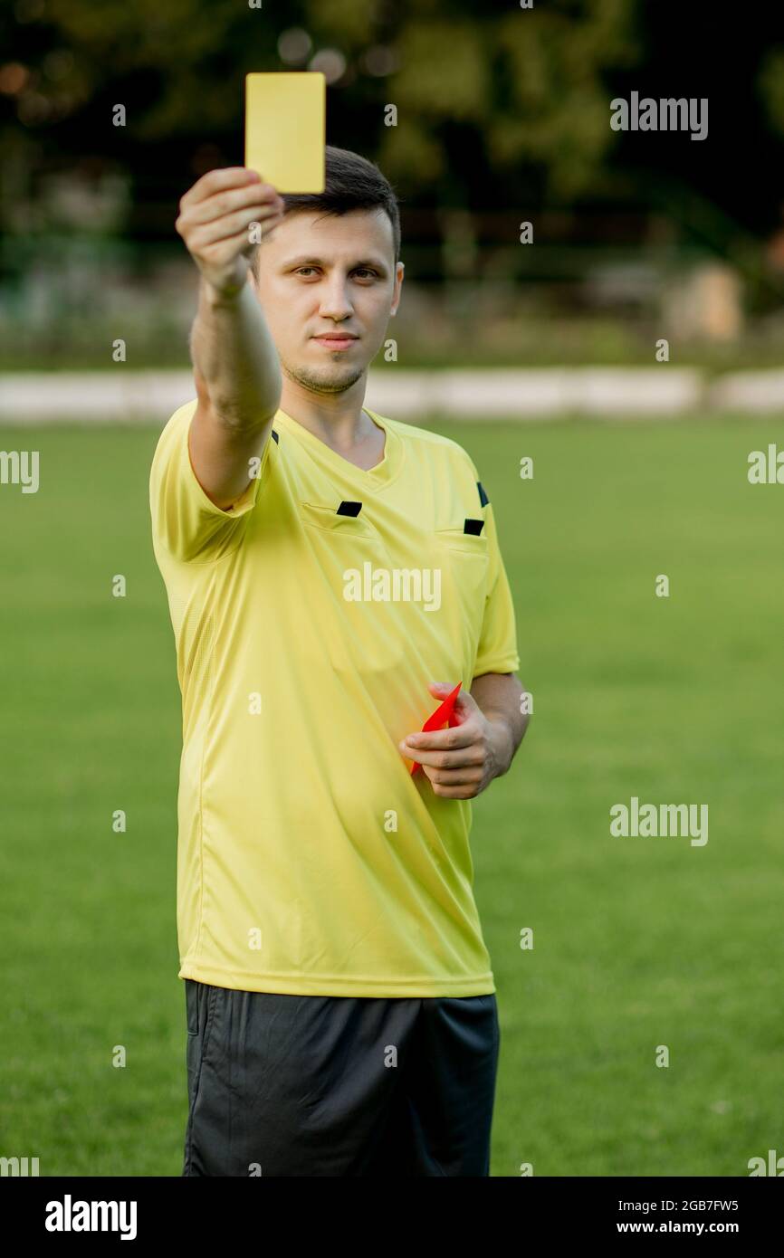 Soccer referee to point out a yellow card to a player in the soccer ...