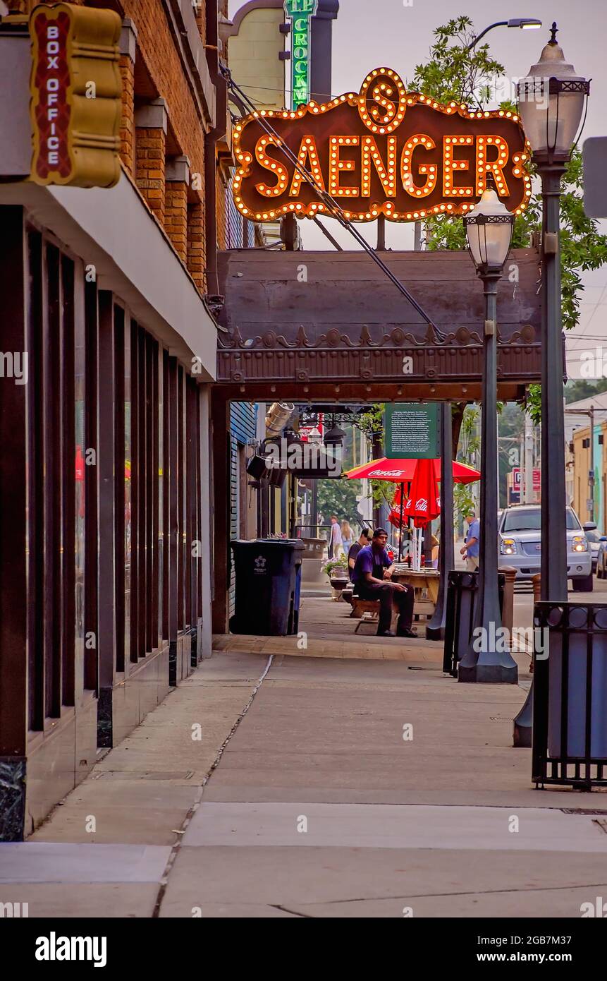 A lighted sign invites passersby to catch a show at the Saenger Theatre ...