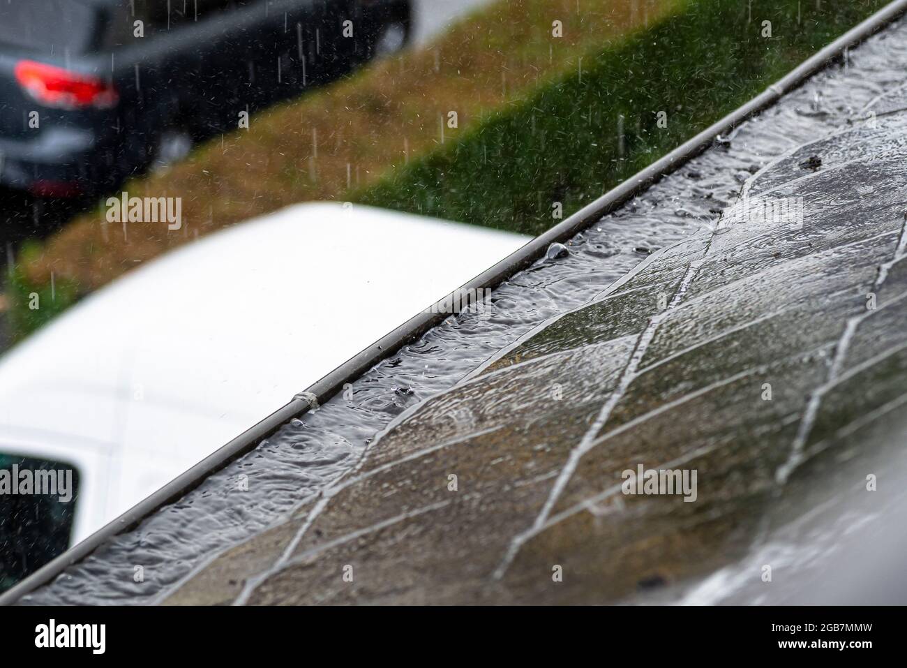Clogged gutter filled with water that overflows in rainy weather Stock ...