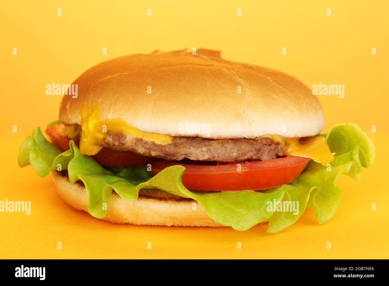 Tasty cheeseburger on yellow background Stock Photo - Alamy
