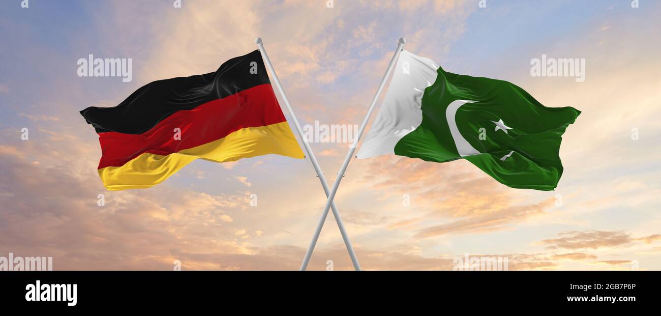 flags of Germany and Pakistan waving in the wind on flagpoles against ...