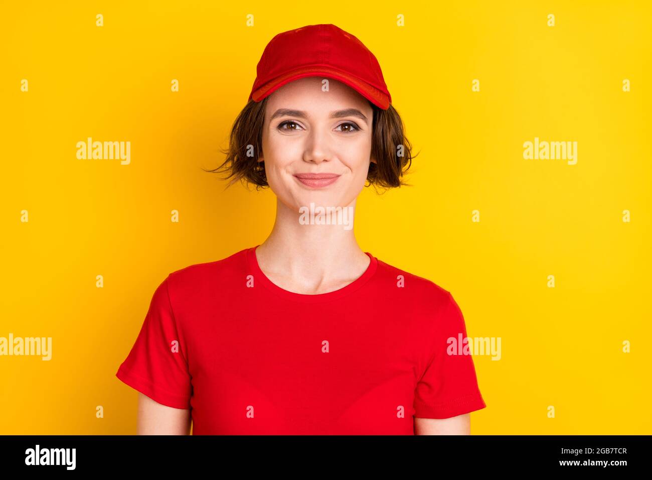 Photo of shiny adorable young deliver lady red workwear smiling ...