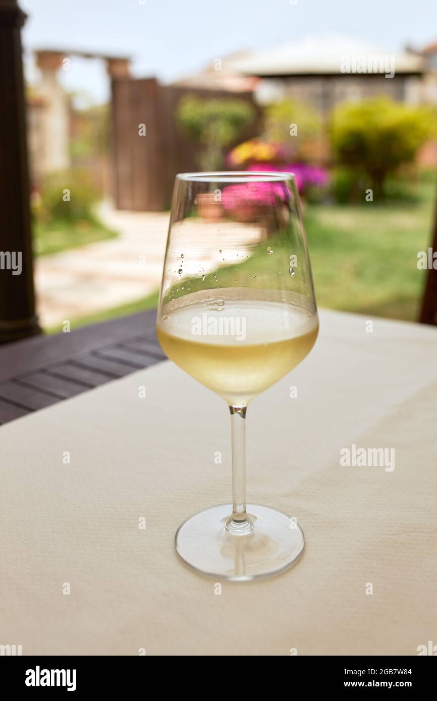 Glass of white wine on a table on a terrace Stock Photo - Alamy
